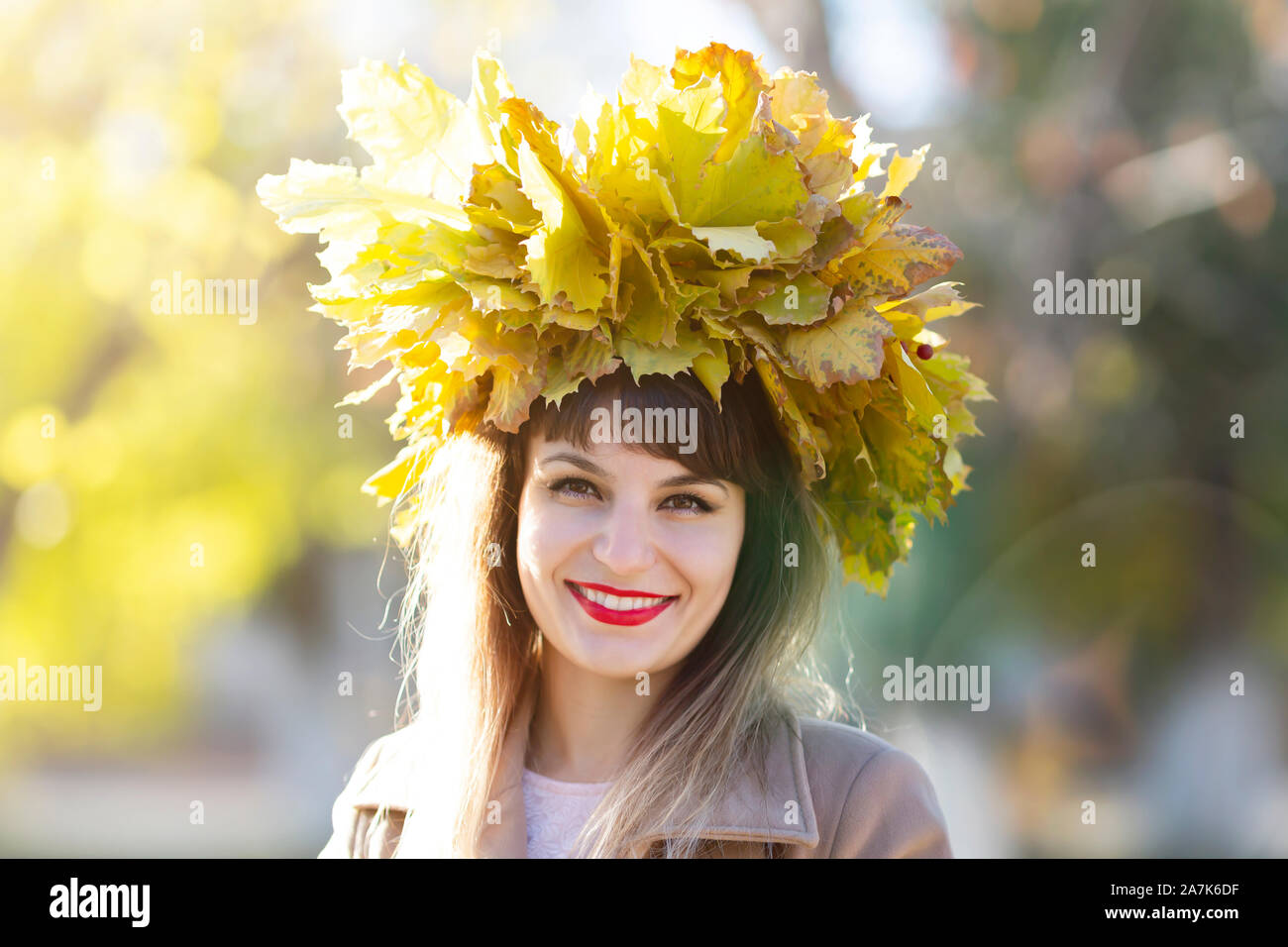 The woman made a hat from autumn fallen leaves for head Stock Photo - Alamy