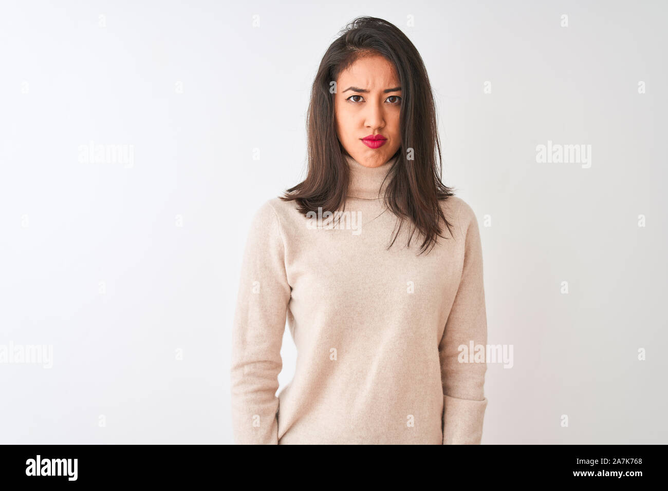 Beautiful chinese woman wearing turtleneck sweater standing over ...