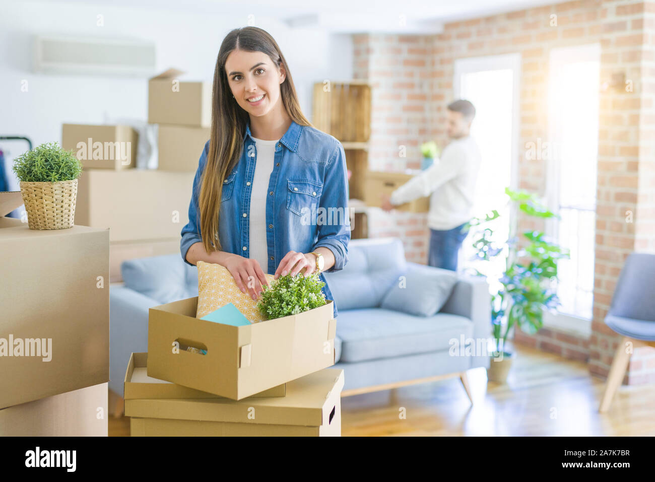 Young couple moving to a new home, beautiful woman smiling moving ...