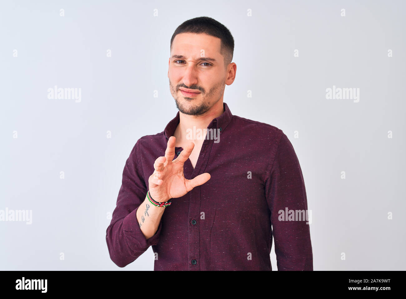 Young handsome business man standing over isolated background disgusted ...
