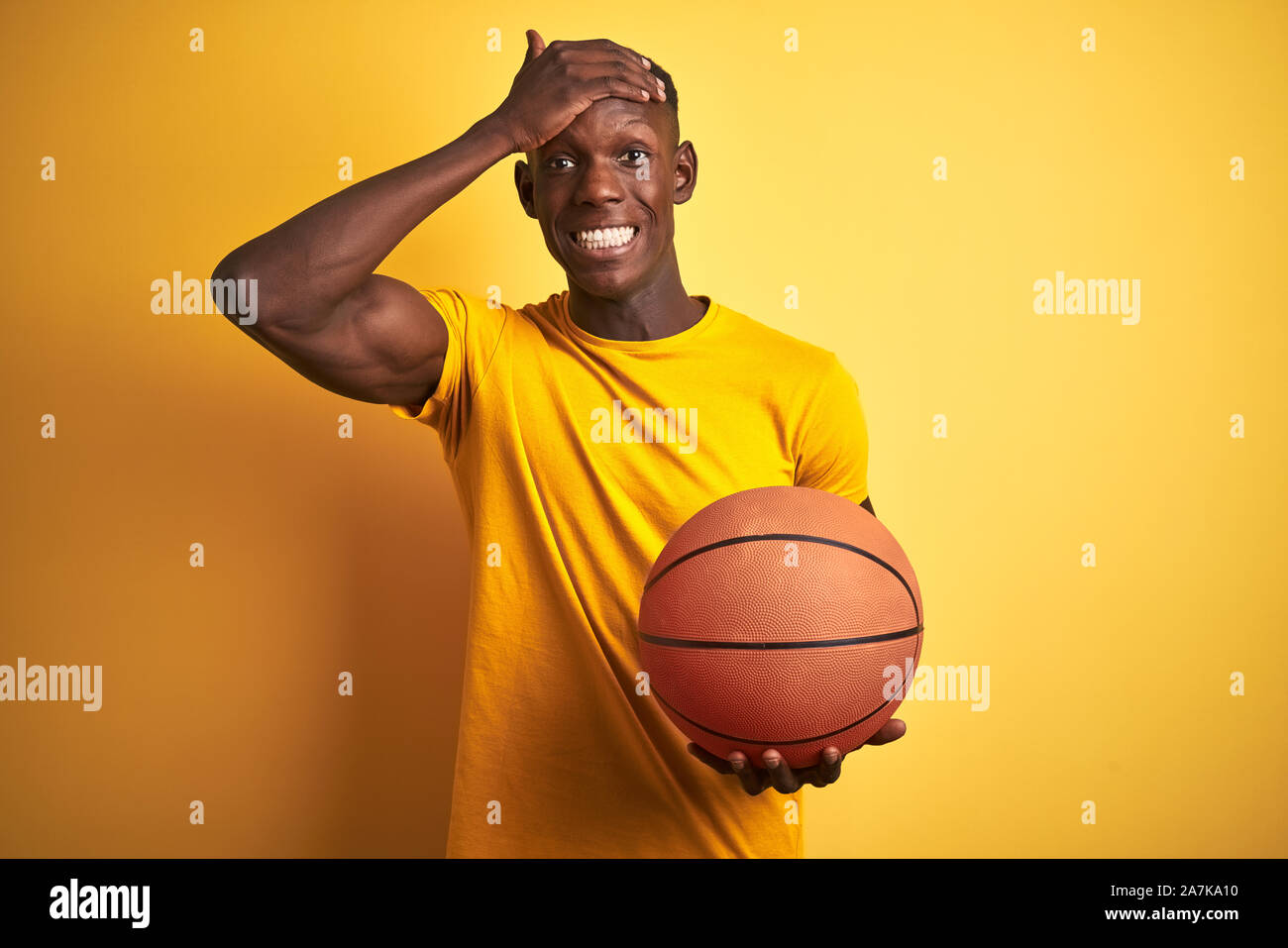 African american athlete man holding basketball ball standing over ...