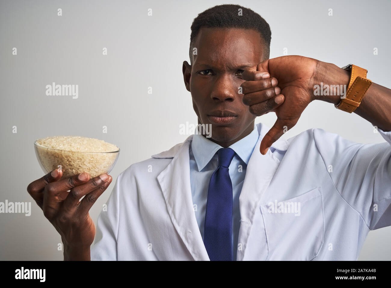 African american doctor man holding bowl with rice standing over ...
