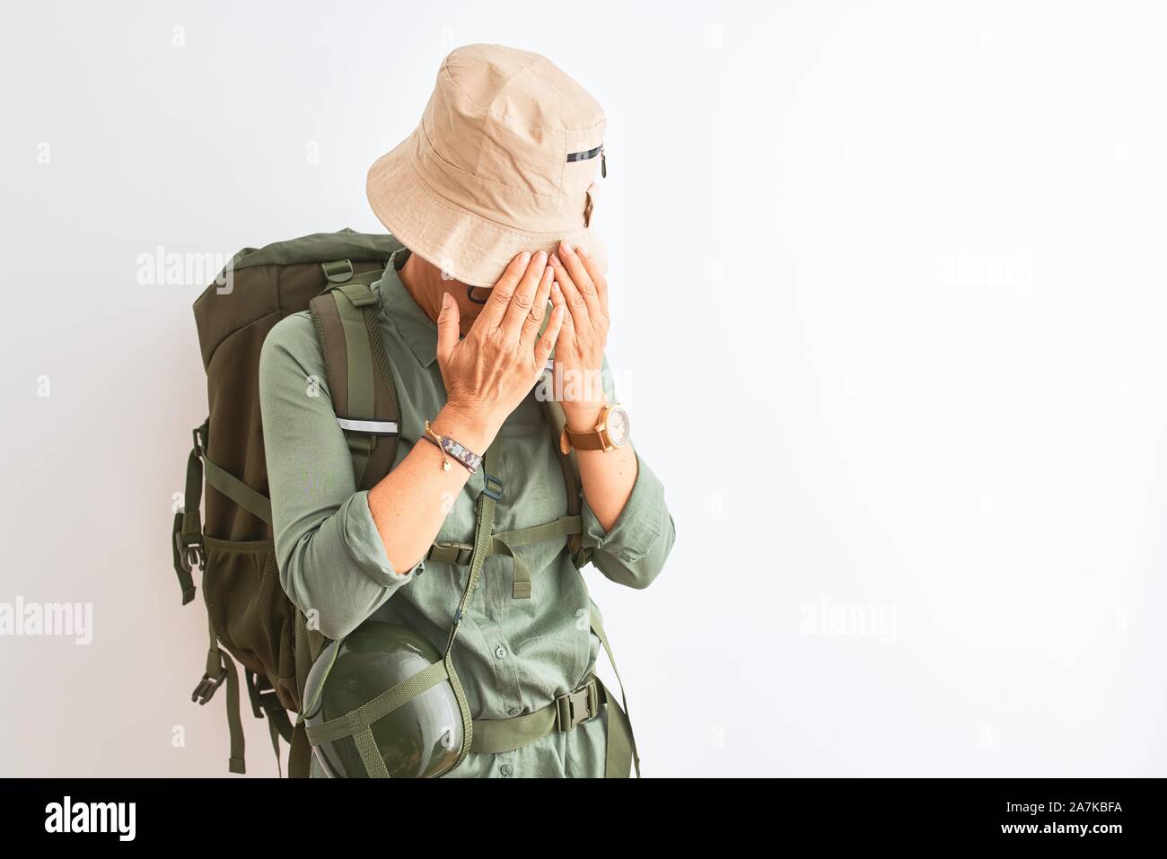 Middle age hiker woman wearing backpack canteen hat glasses over ...