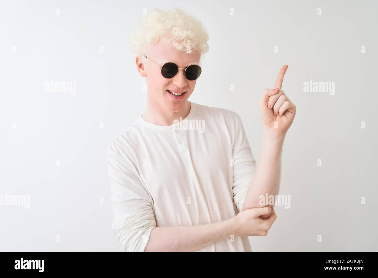 Young albino blond man wearing t-shirt and sunglasses over isolated ...