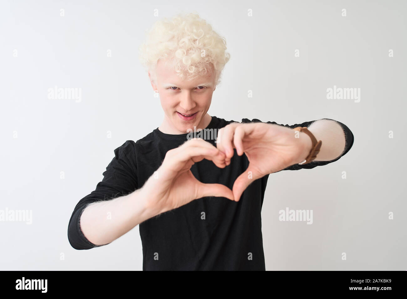 Young albino blond man wearing black t-shirt standing over isolated ...
