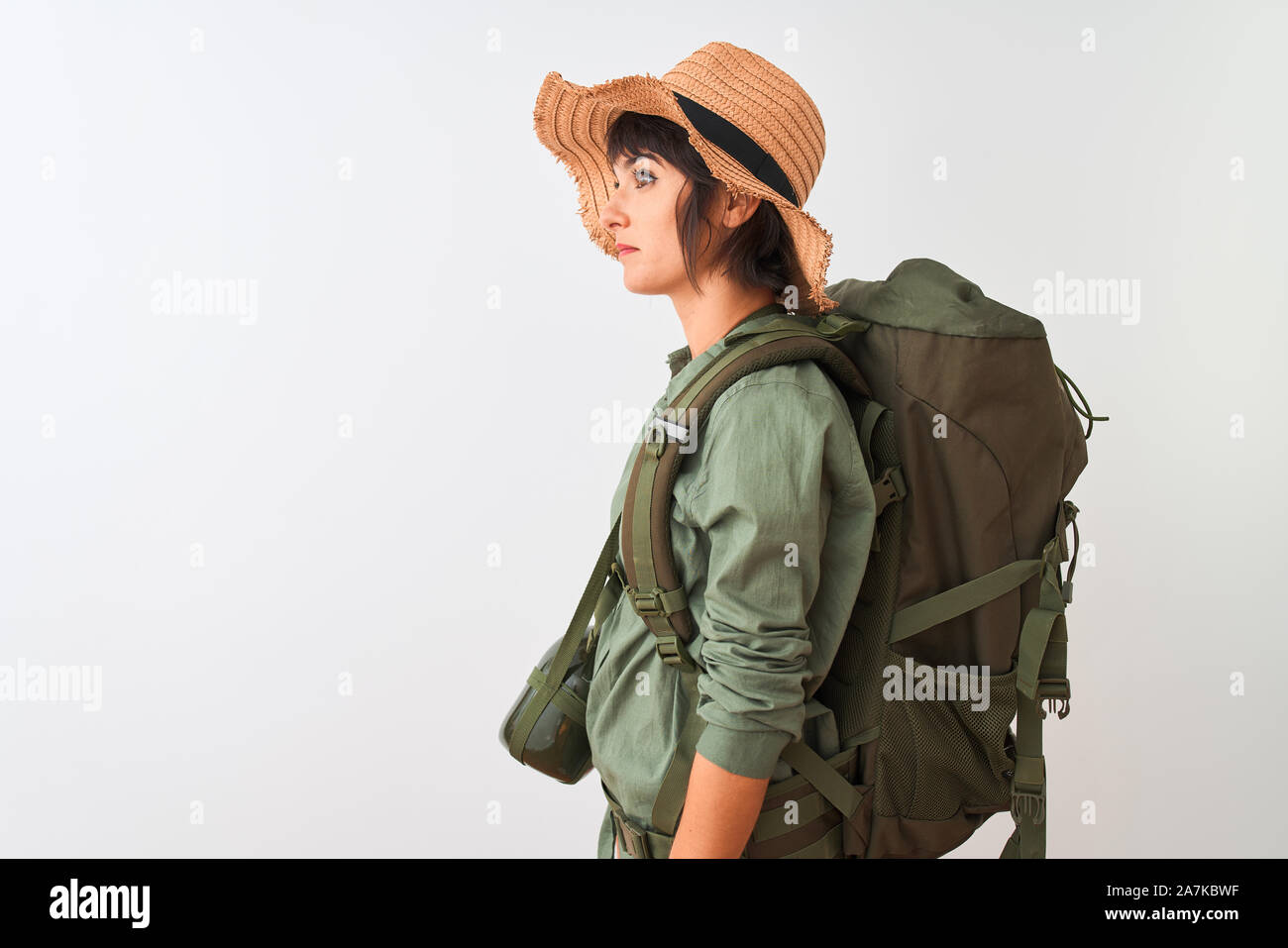 Hiker woman wearing backpack hat and water canteen over isolated white ...