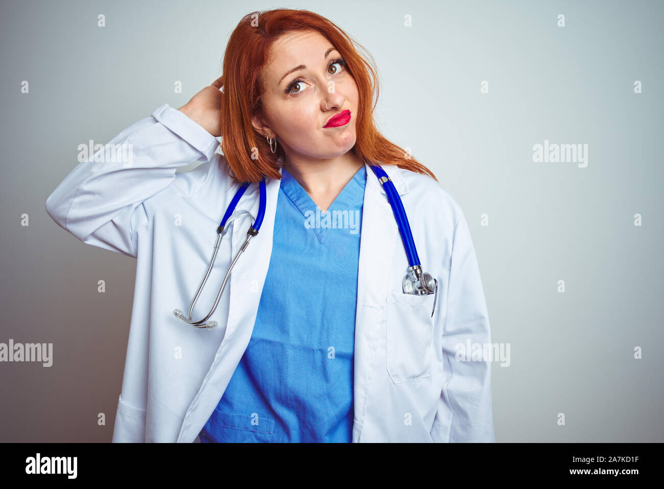 Young redhead doctor woman using stethoscope over white isolated ...