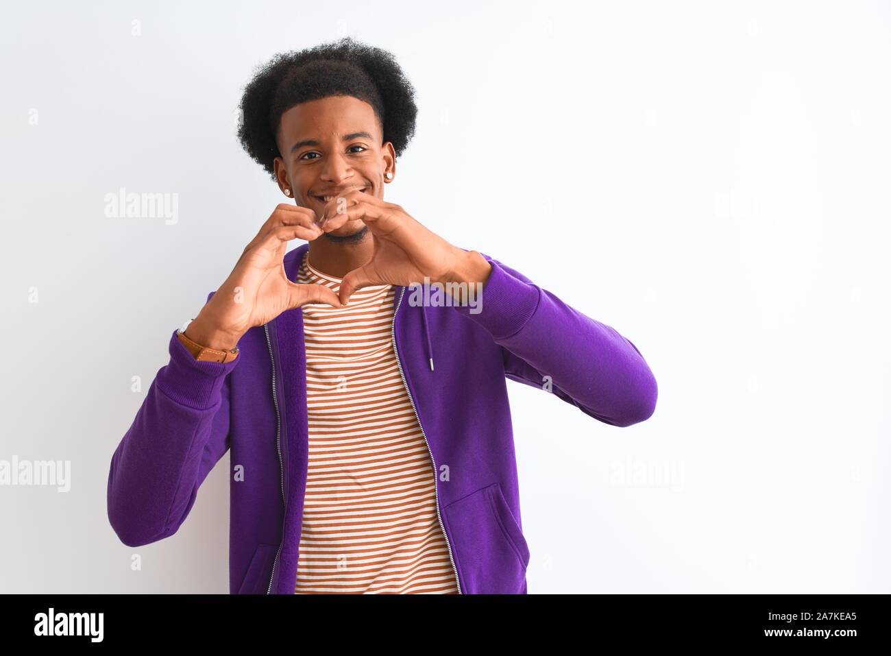 African american man wearing purple sweatshirt standing over isolated ...