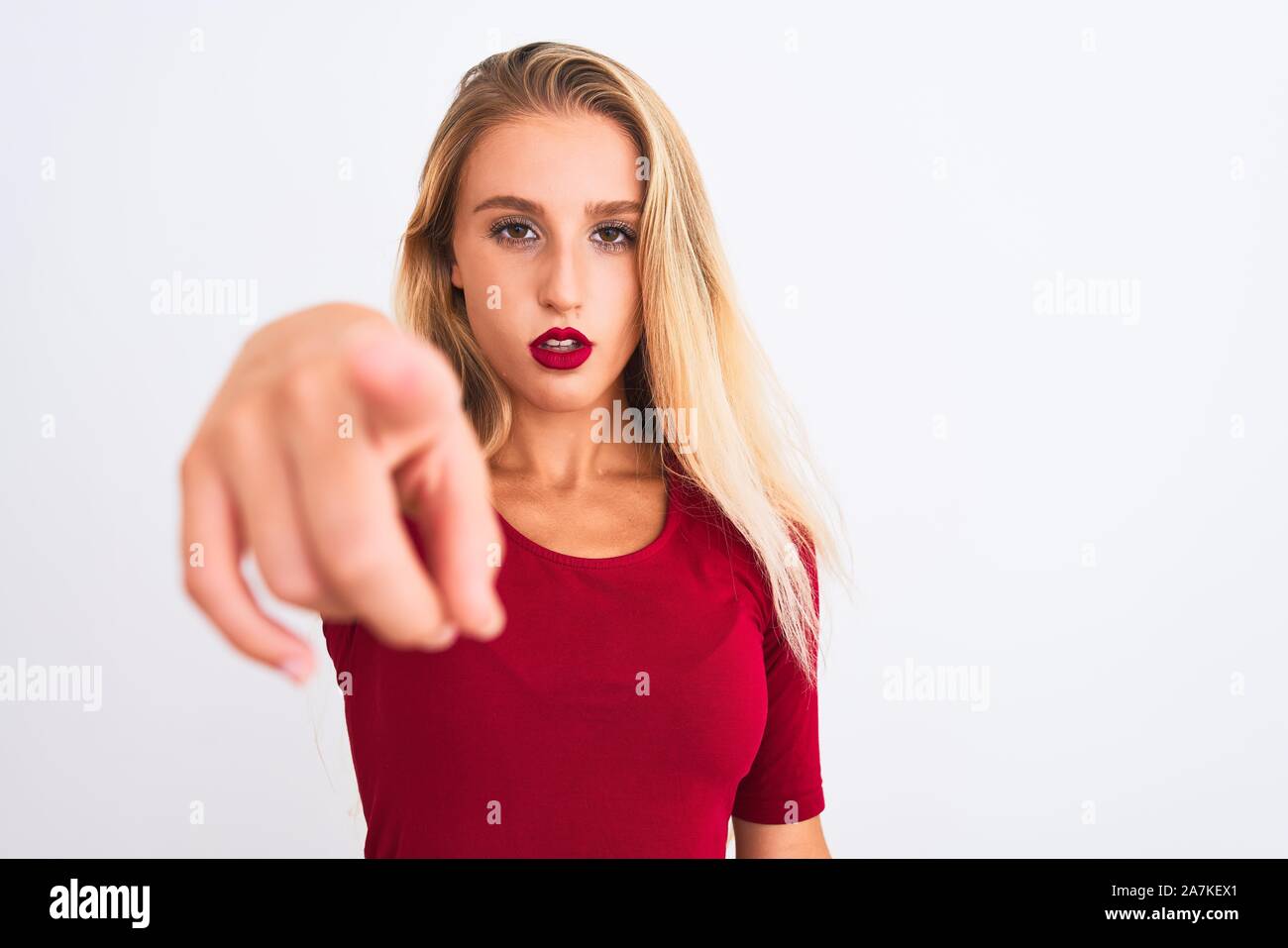 Young beautiful woman wearing red t-shirt standing over isolated white ...