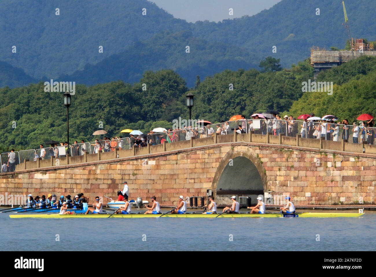 People watch rowing teams competing at the West-lake during the 2019 ...