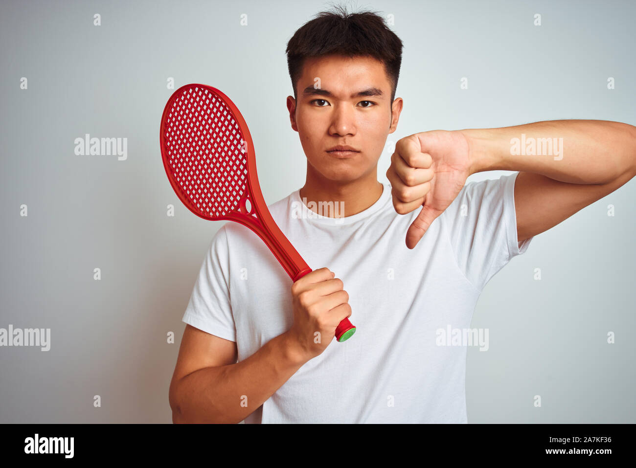 Asian chinese sportsman holding tennis racket standing over isolated ...