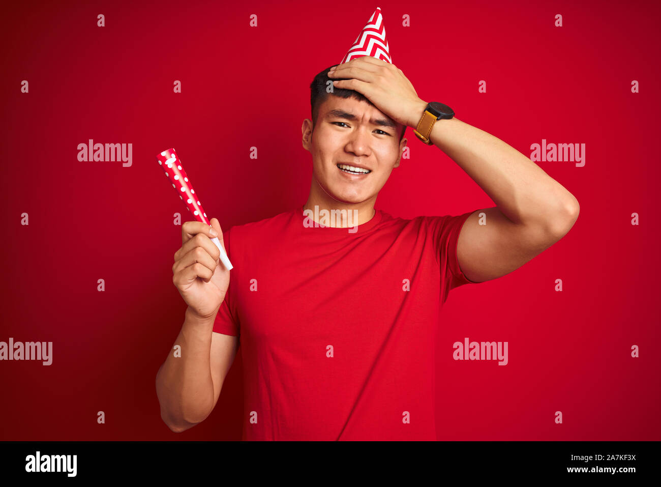 Asian chinese man on birthday celebration wearing funny hat over ...