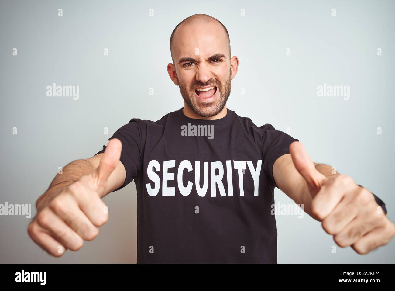 Young safeguard man wearing security uniform over isolated background ...