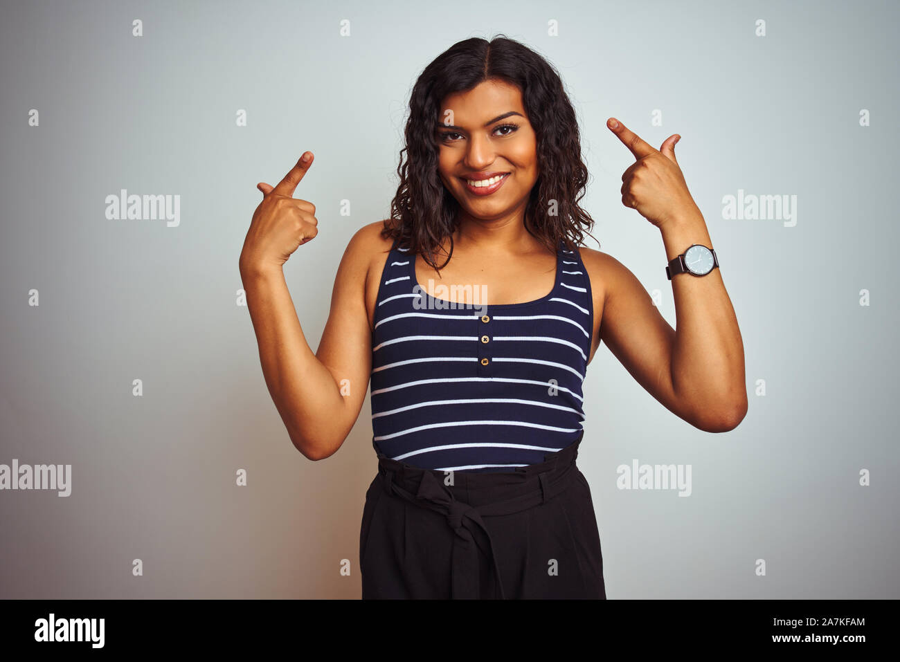 Transsexual transgender woman wearing striped t-shirt over isolated ...