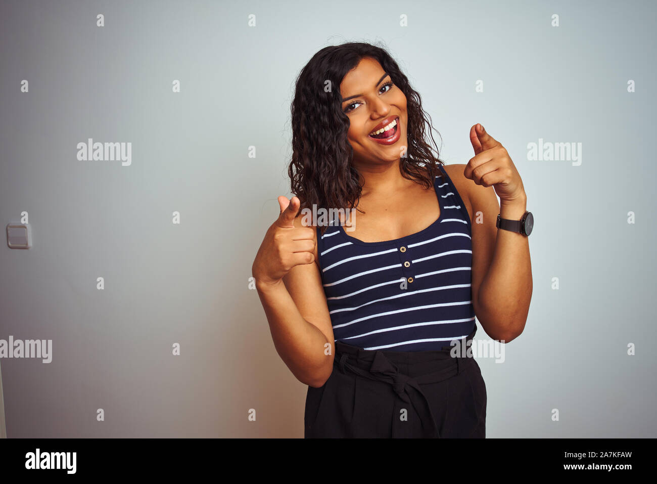Transsexual transgender woman wearing striped t-shirt over isolated ...