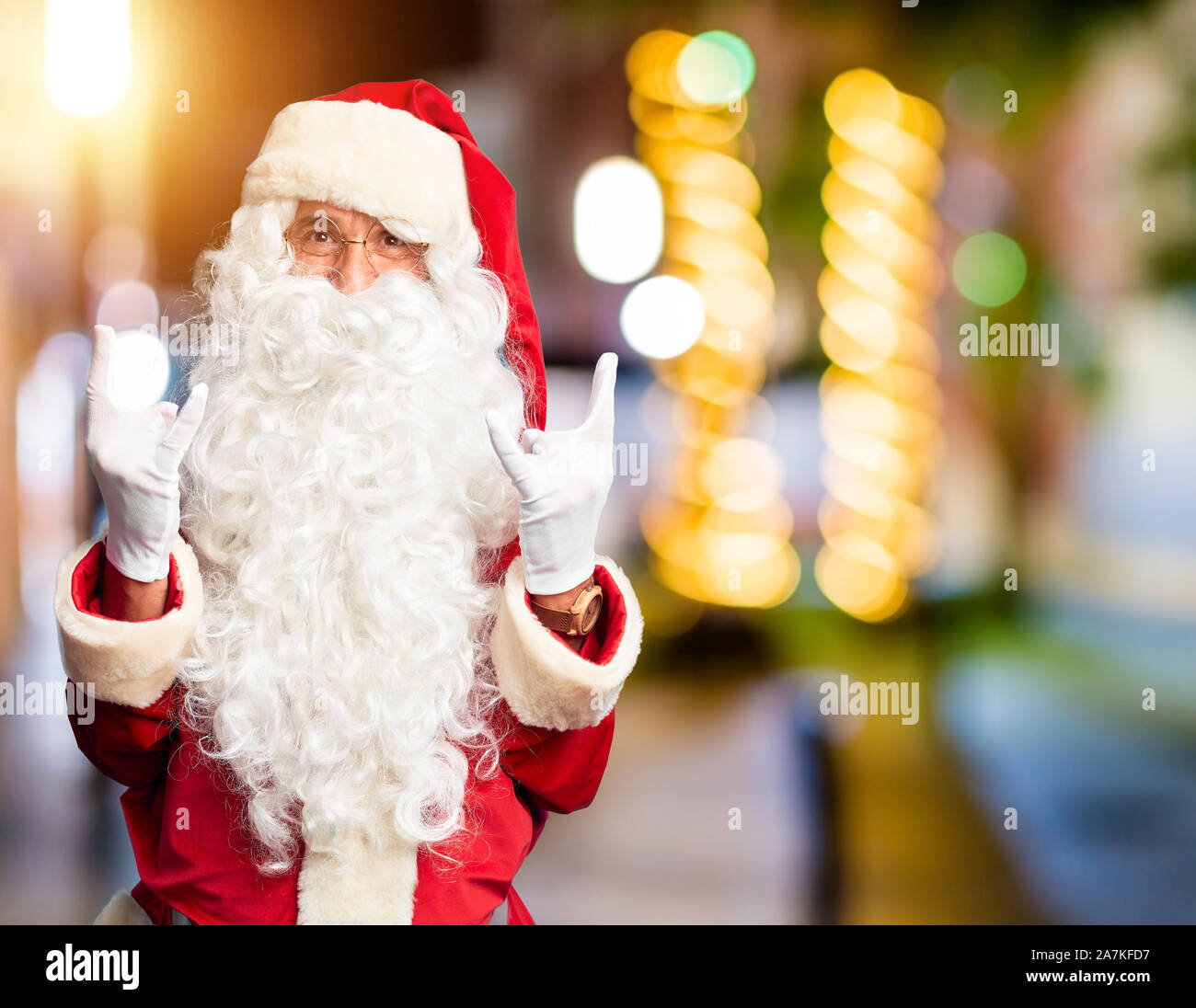 Middle age handsome man wearing Santa Claus costume and beard standing ...