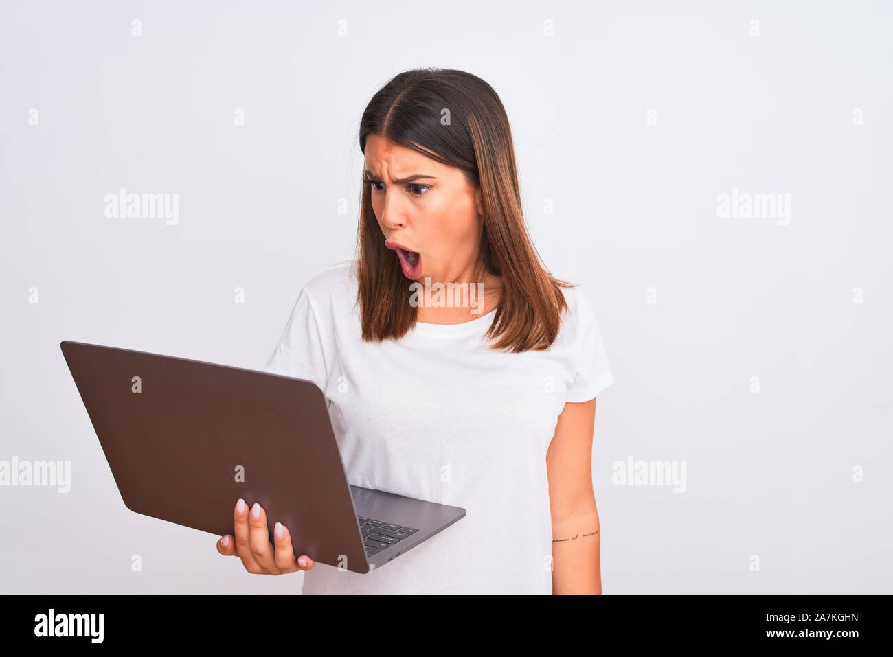 Beautiful young woman working using computer laptop over white ...