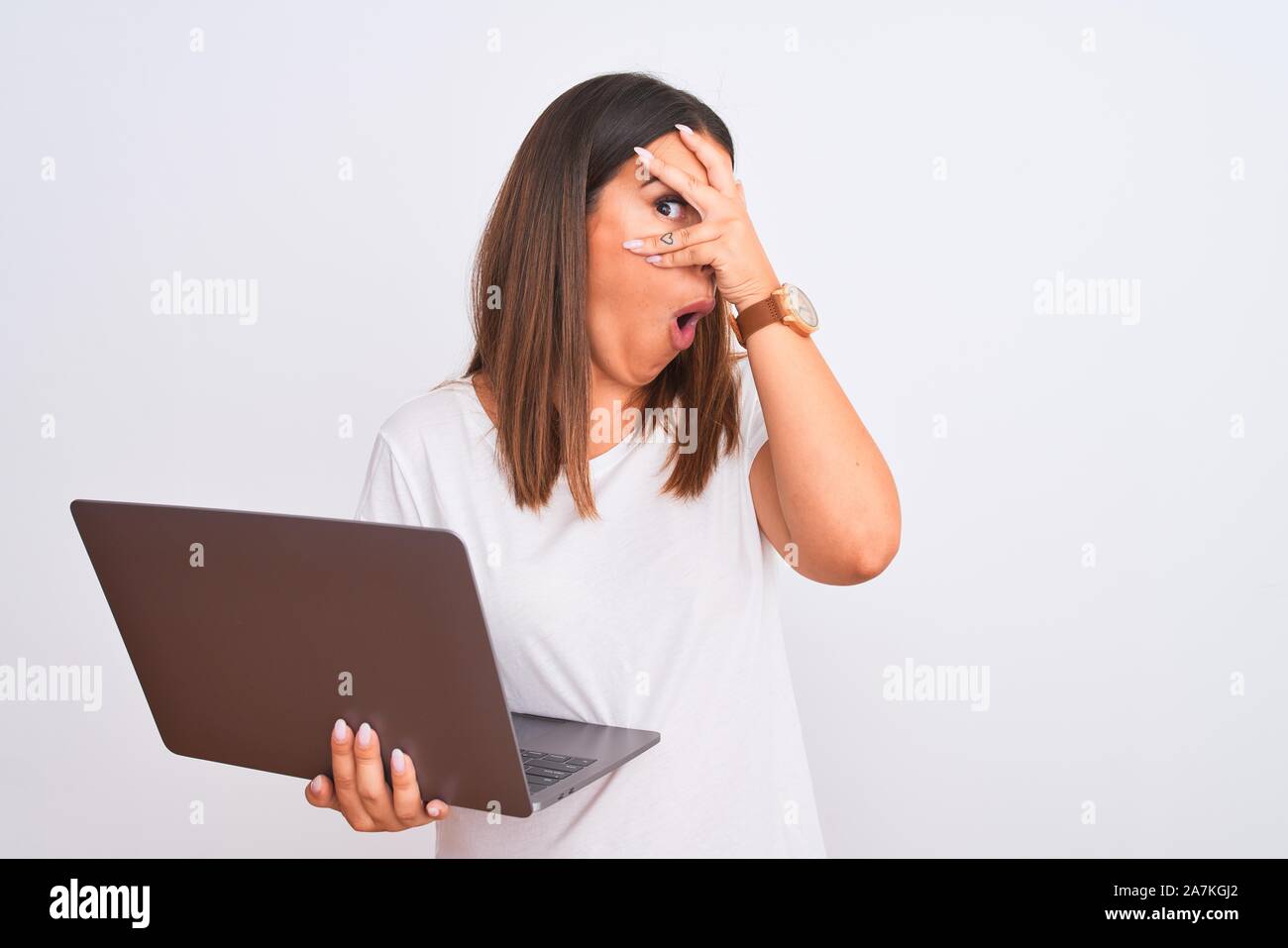 Beautiful young woman working using computer laptop over white ...