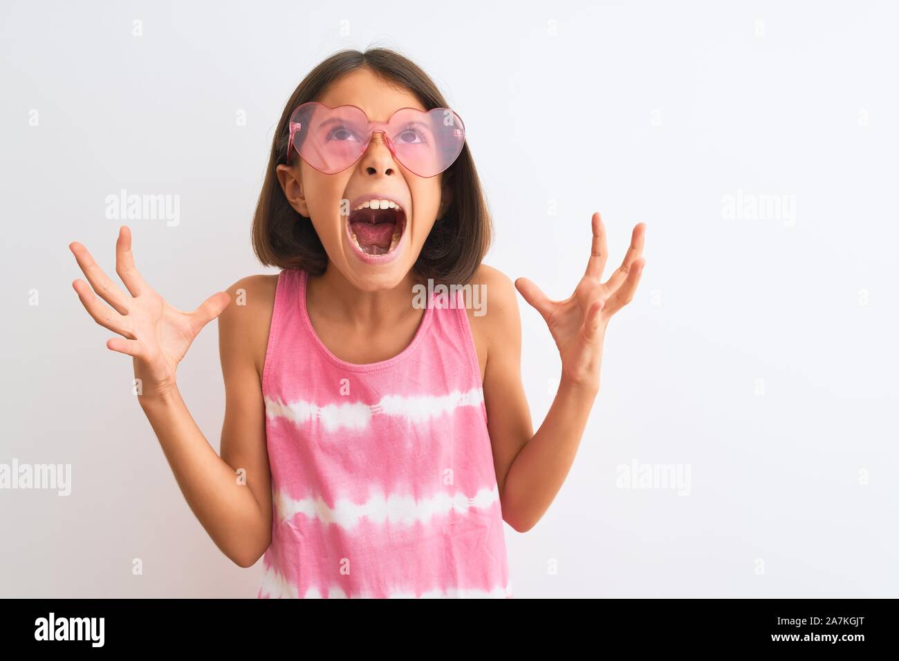 Young beautiful child girl wearing pink t-shirt and sunglasses over ...