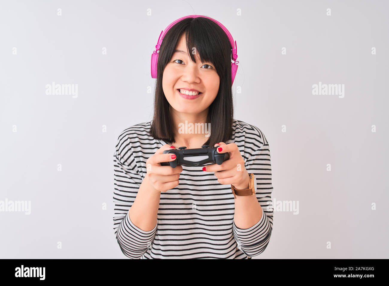 Chinese gamer woman playing video game using headphones over isolated ...