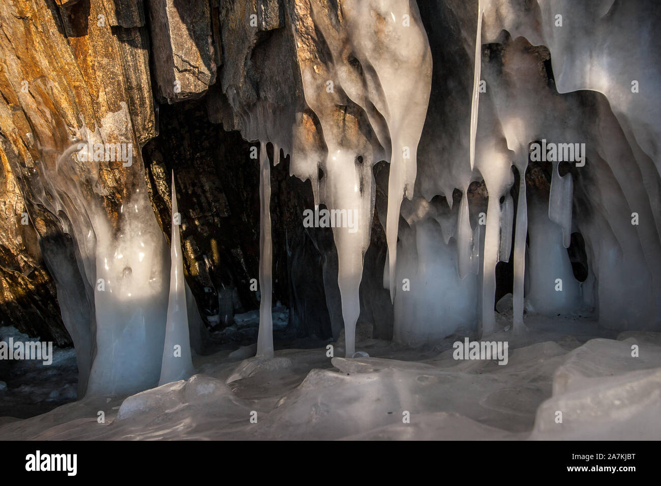 Large thick icicles on the rocks and several ice stalagmites. Icicles ...