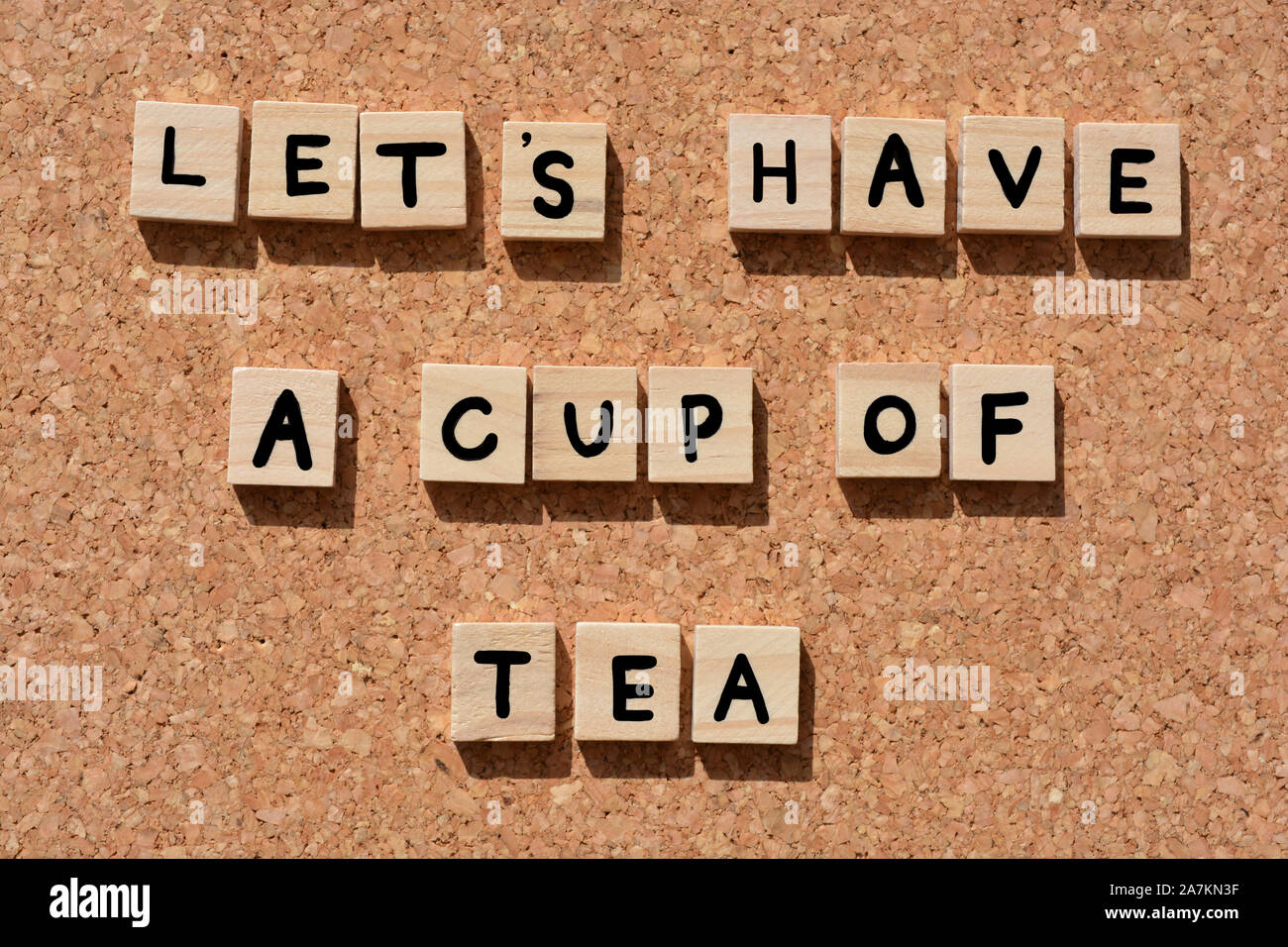 Lets Have a Cup of Tea, words in 3d wooden alphabet letters on a cork ...