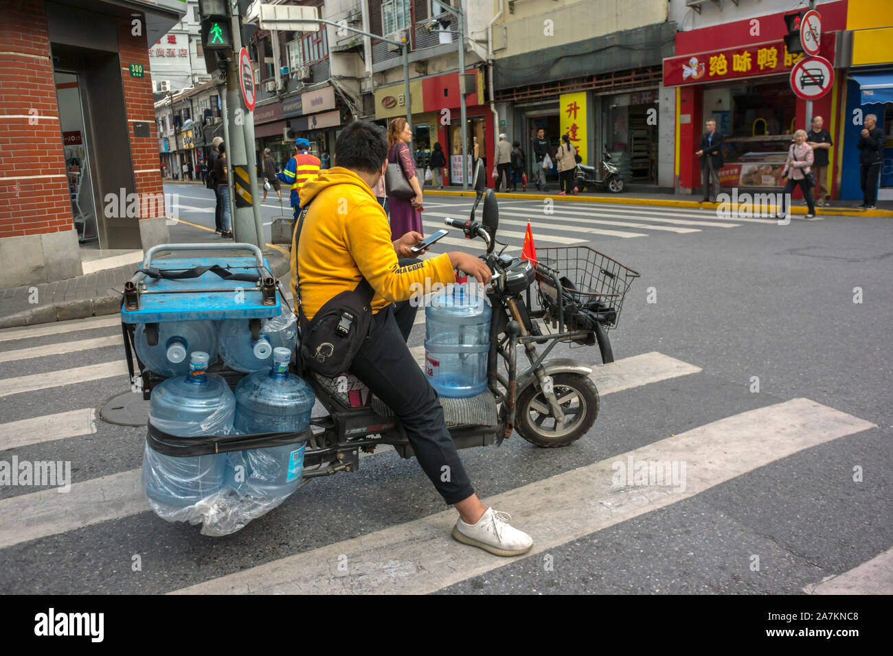 Shanghai, China, Busy Street Scenes, Delivery man on Scooter with Water ...