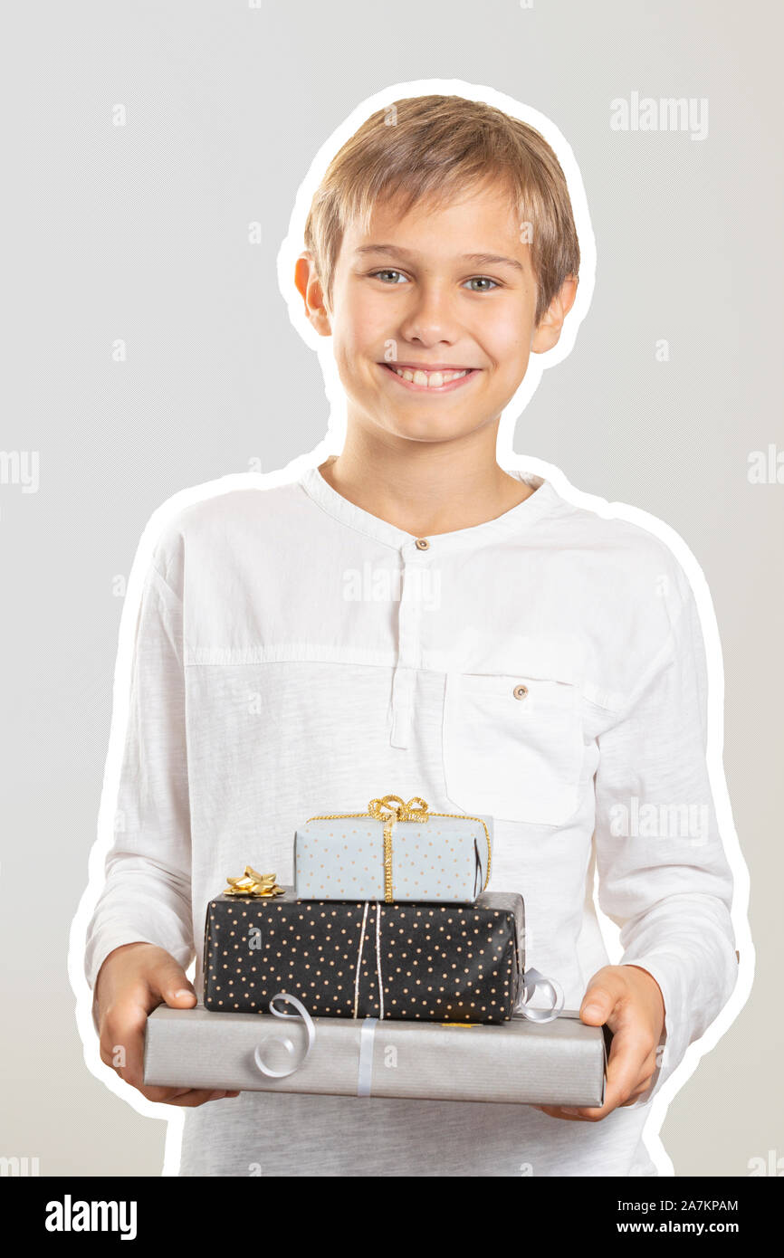 Happy boy holding stack paper wrapped present gift boxes. Magazine ...