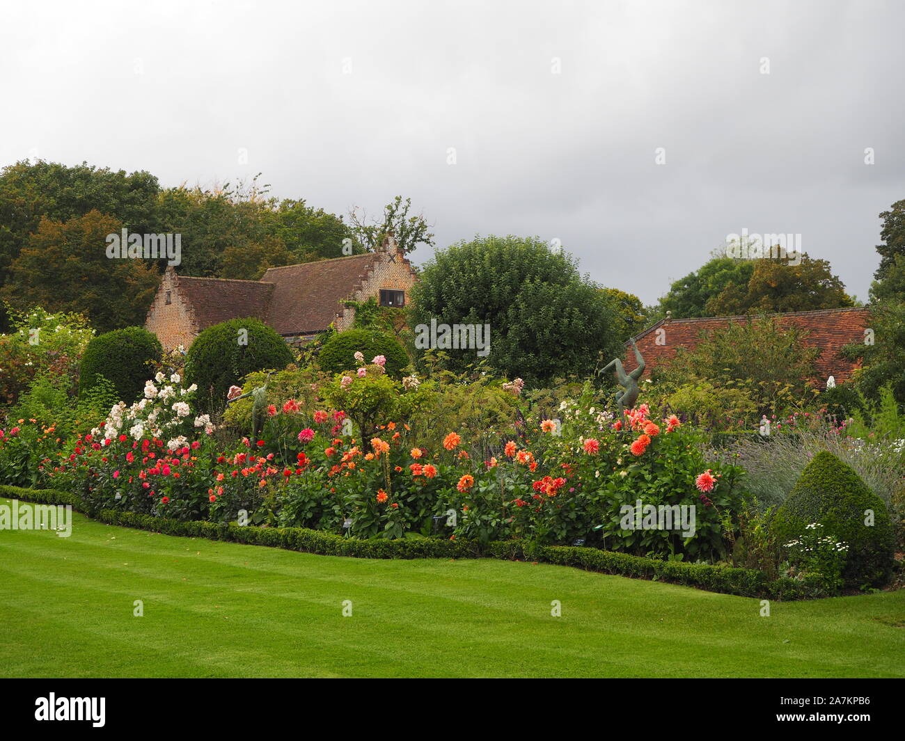 Beautiful curved plant border packed with orange, pink and cerise ...