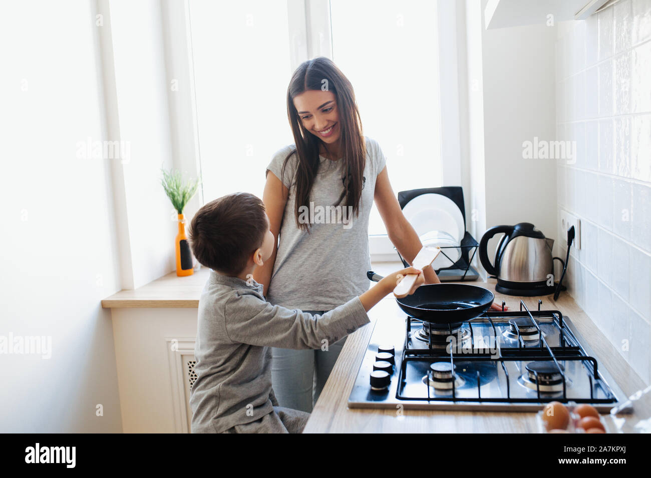 Cute little boy with his beautiful mother cooking together Stock Photo ...