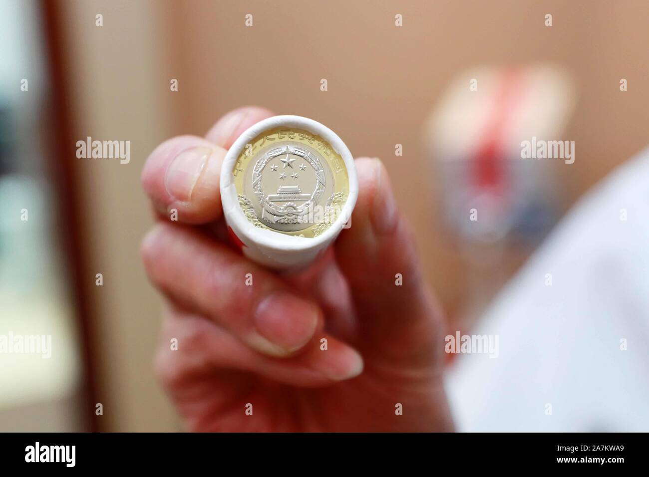 A commemorative coin lover demonstrates his gain of the 10 Yuan ...
