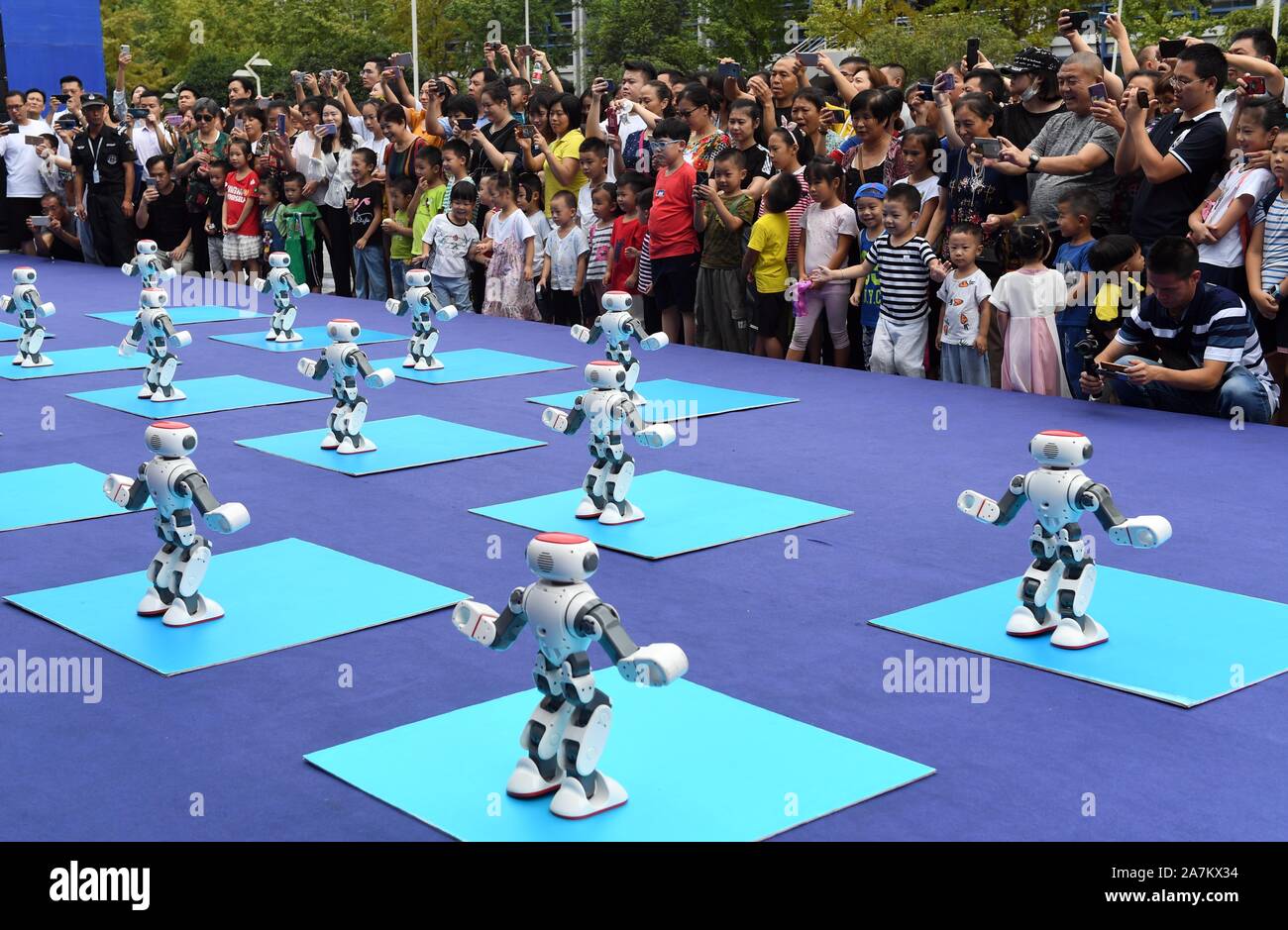 People watch robots dance in a park in Chongqing, China, 28 August 2019 ...