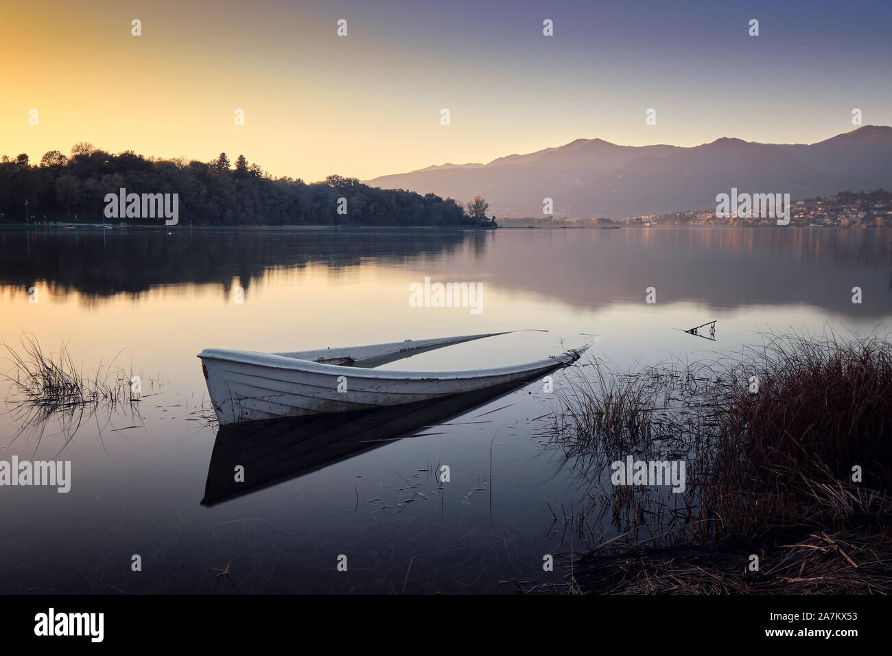 Italian lake with sunken forgotten wooden rowing boat, Lecco, Lombardy ...