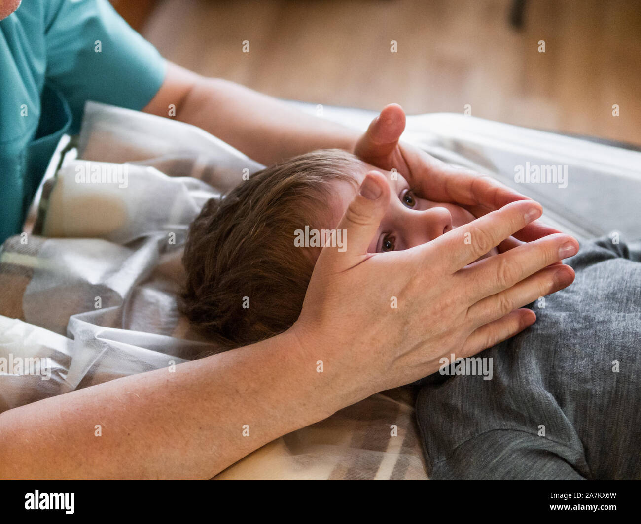Real osteopath does physiological skull therapy for a child. Osteopathy ...