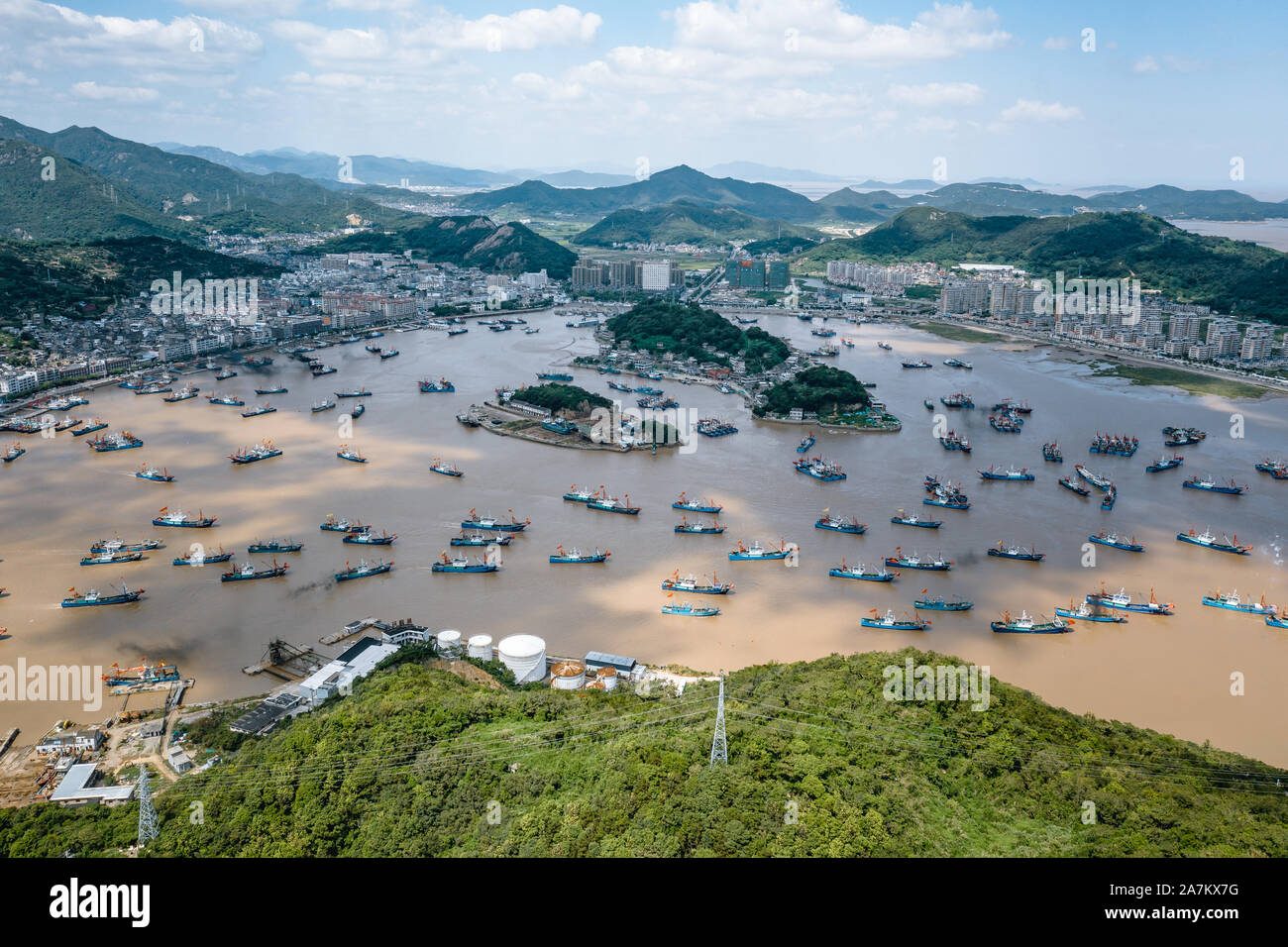 An aerial view of thousands of fishing boats heading towards the ocean ...