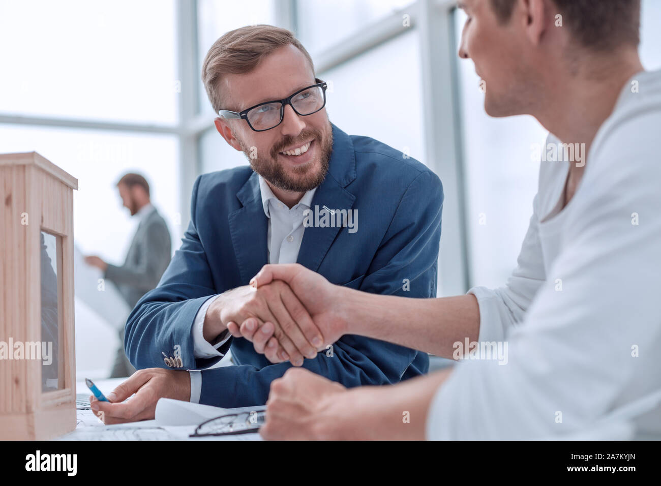 architect shaking hands with the customer sitting at the table Stock ...