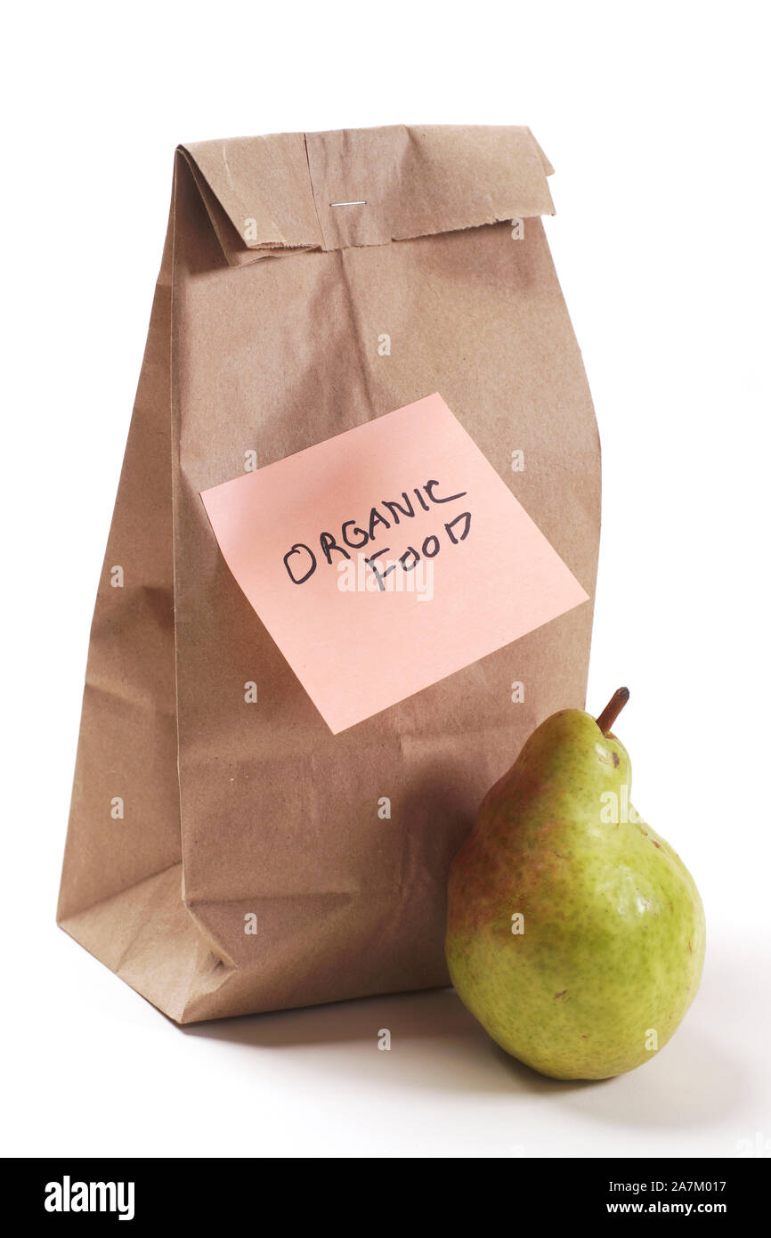 Brown paper closed bag with sticky note with text pasted to it ...