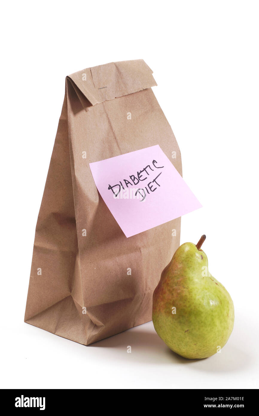 Brown paper closed bag with sticky note with text pasted to it ...