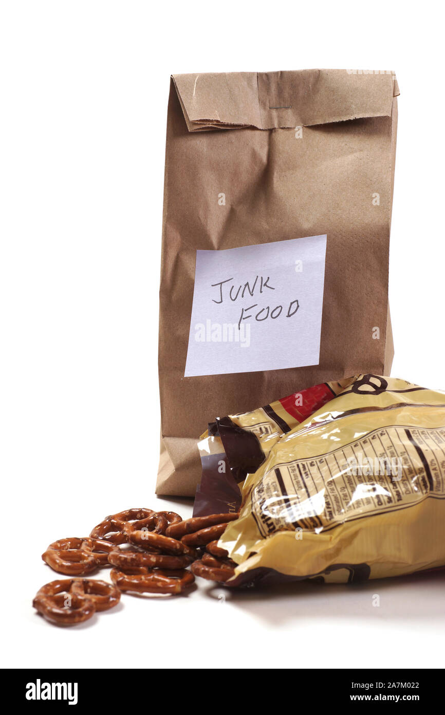 Brown paper closed bag with sticky note with text pasted to it ...