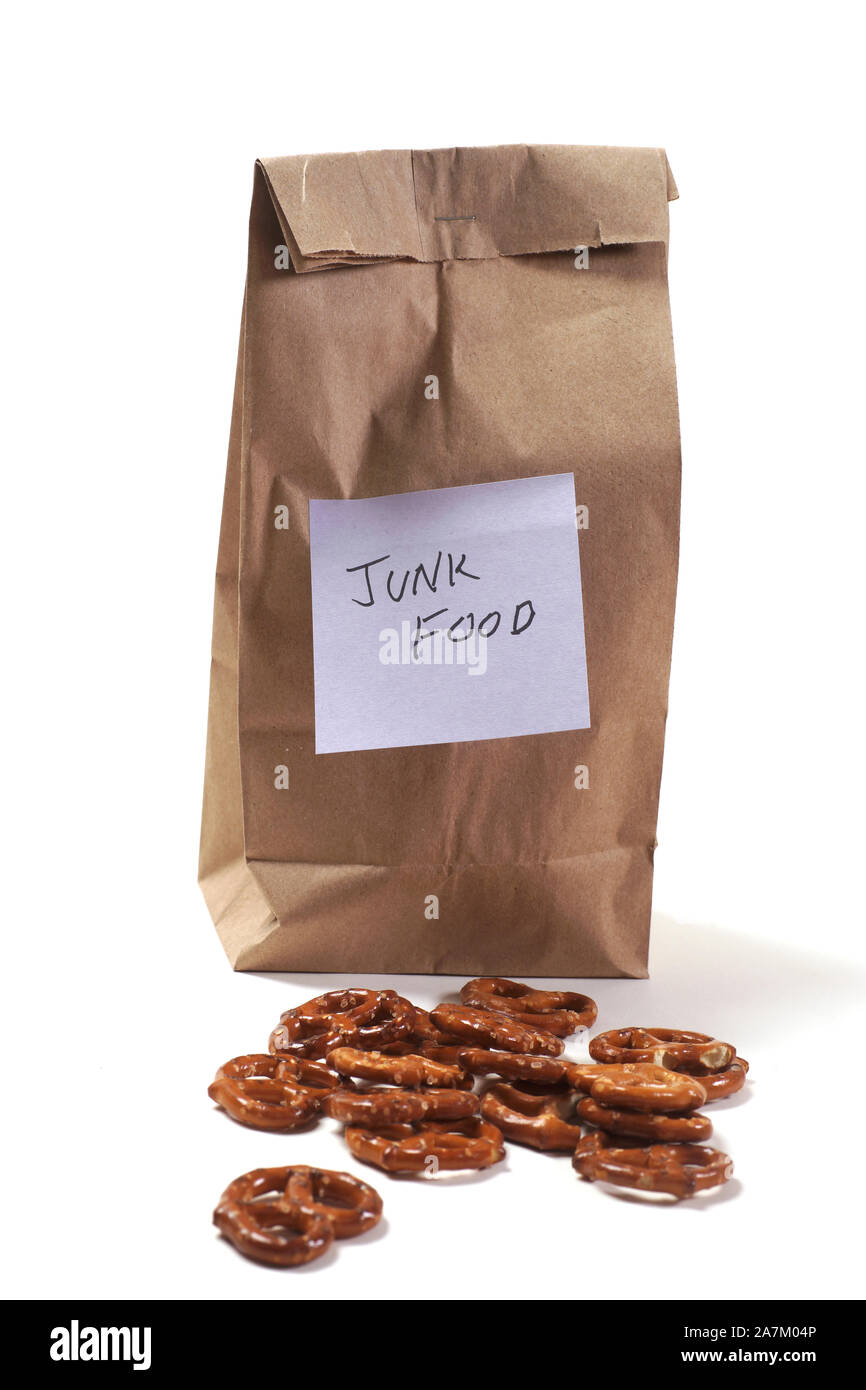 Brown paper closed bag with sticky note with text pasted to it ...