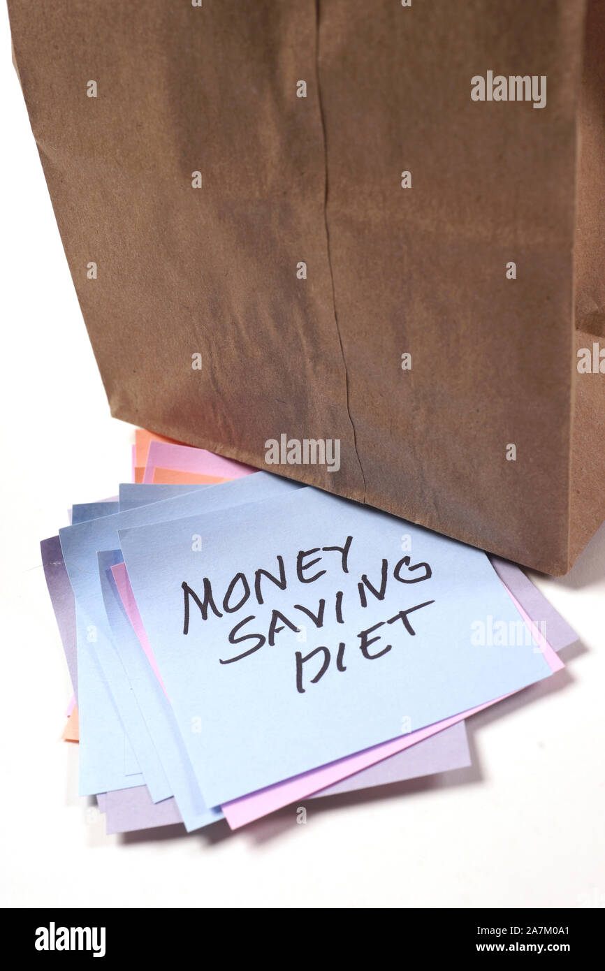 Brown paper closed bag with sticky note with text pasted to it ...