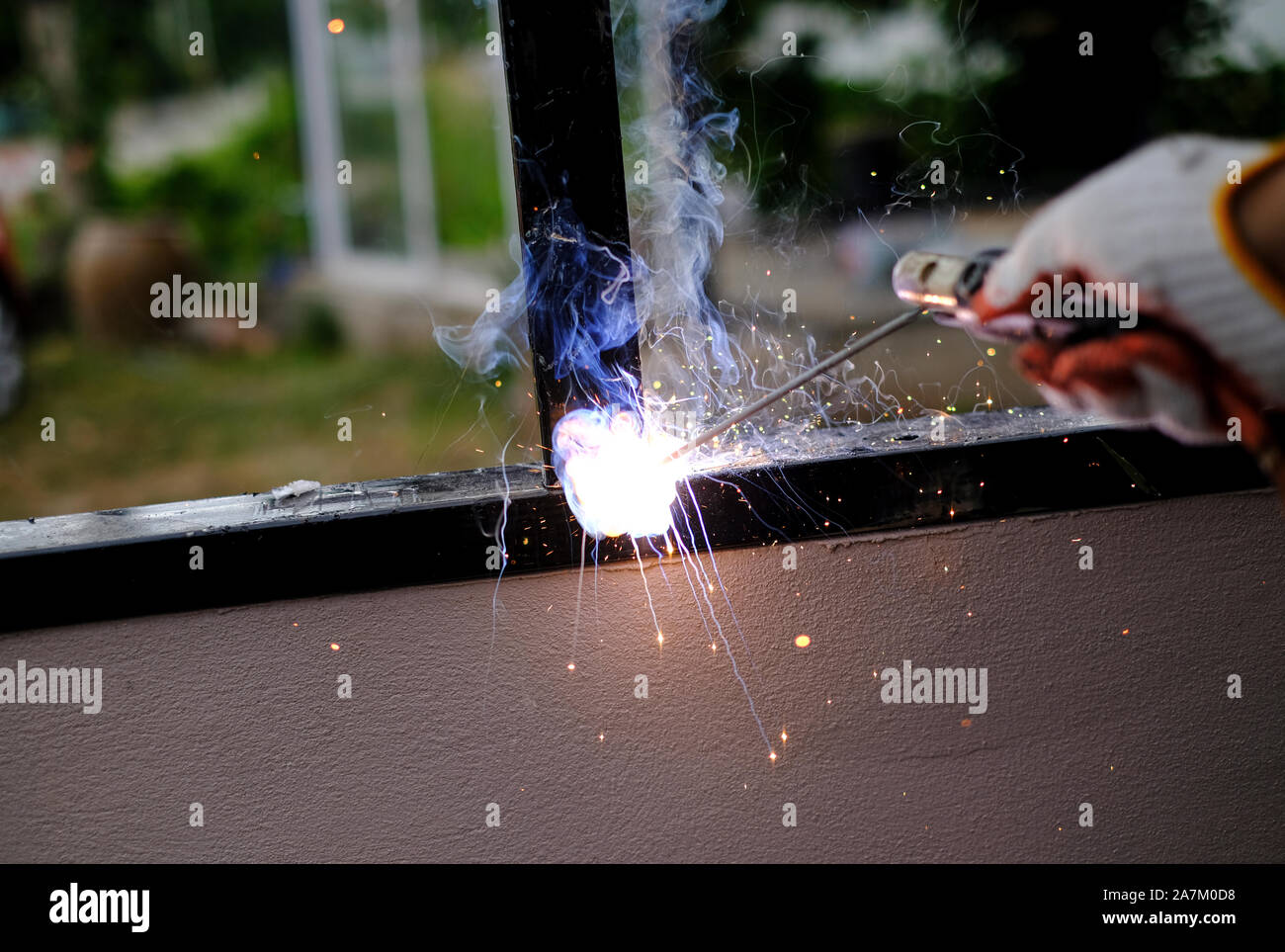 Welder Technician are welding steel with sparks flying Stock Photo - Alamy