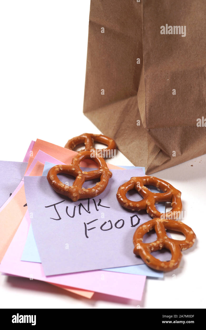 Brown paper closed bag with sticky note with text pasted to it ...