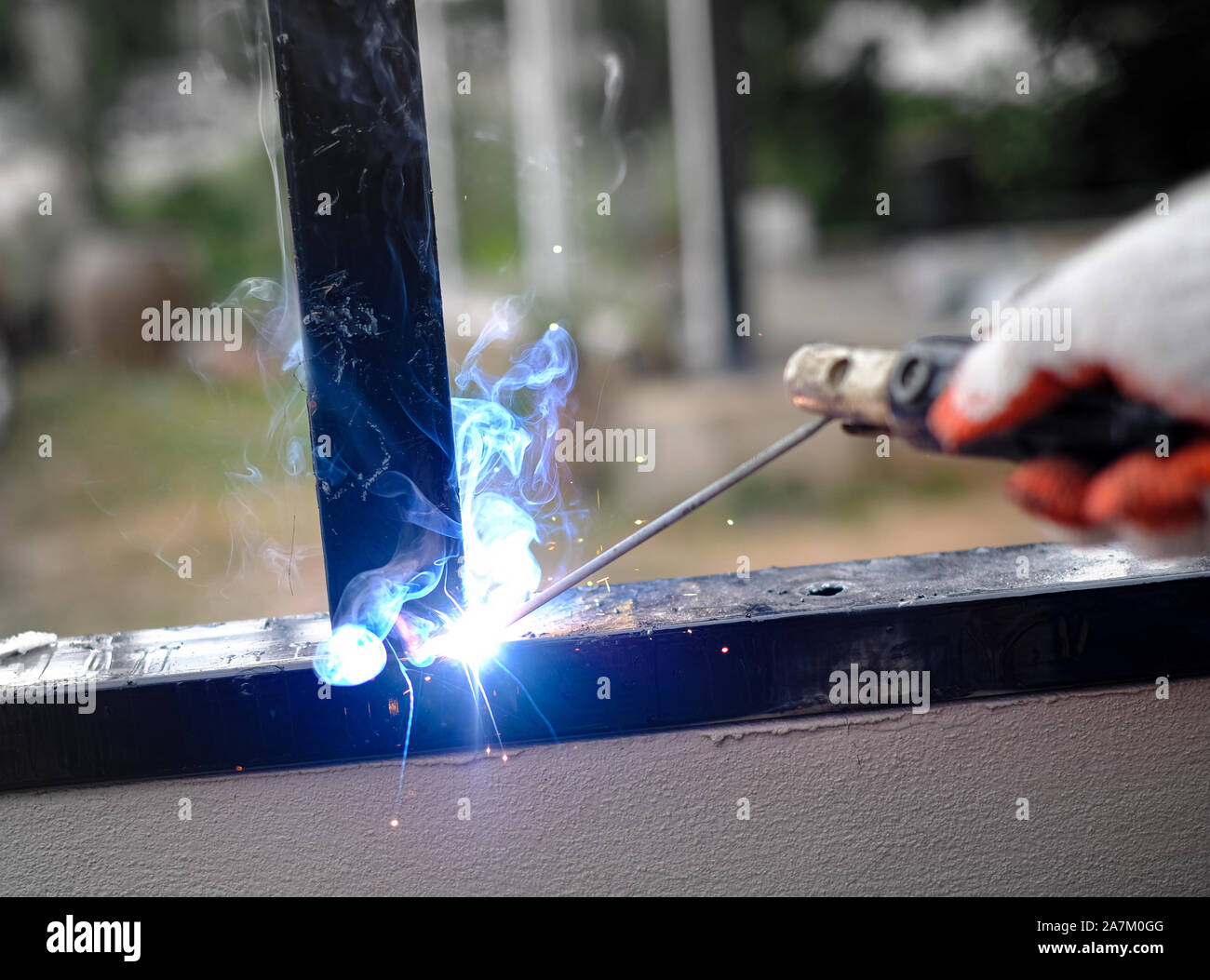 Welder Technician are welding steel with sparks flying Stock Photo - Alamy