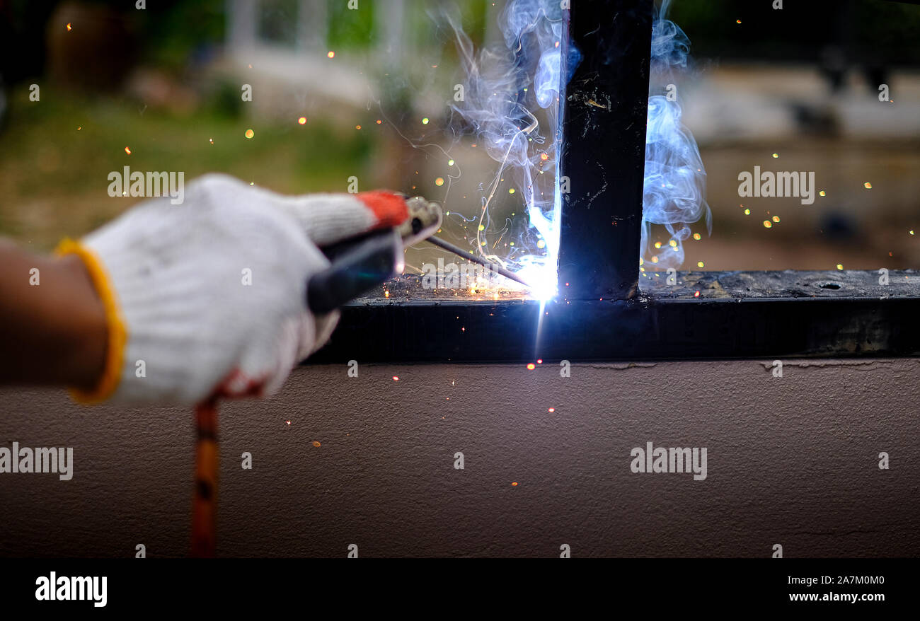 Welder Technician are welding steel with sparks flying Stock Photo - Alamy