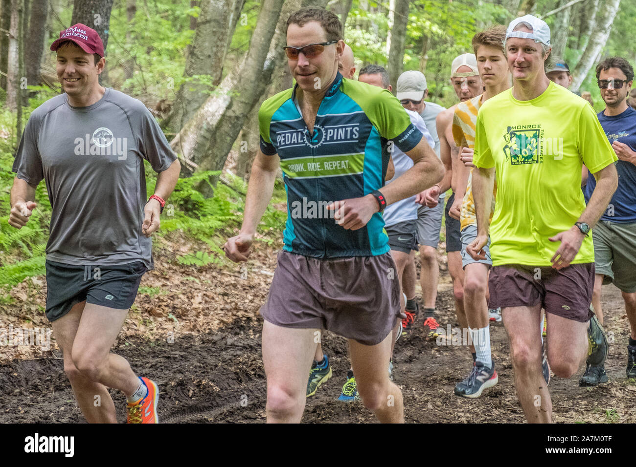 People running in a race along a wooded trail Stock Photo - Alamy