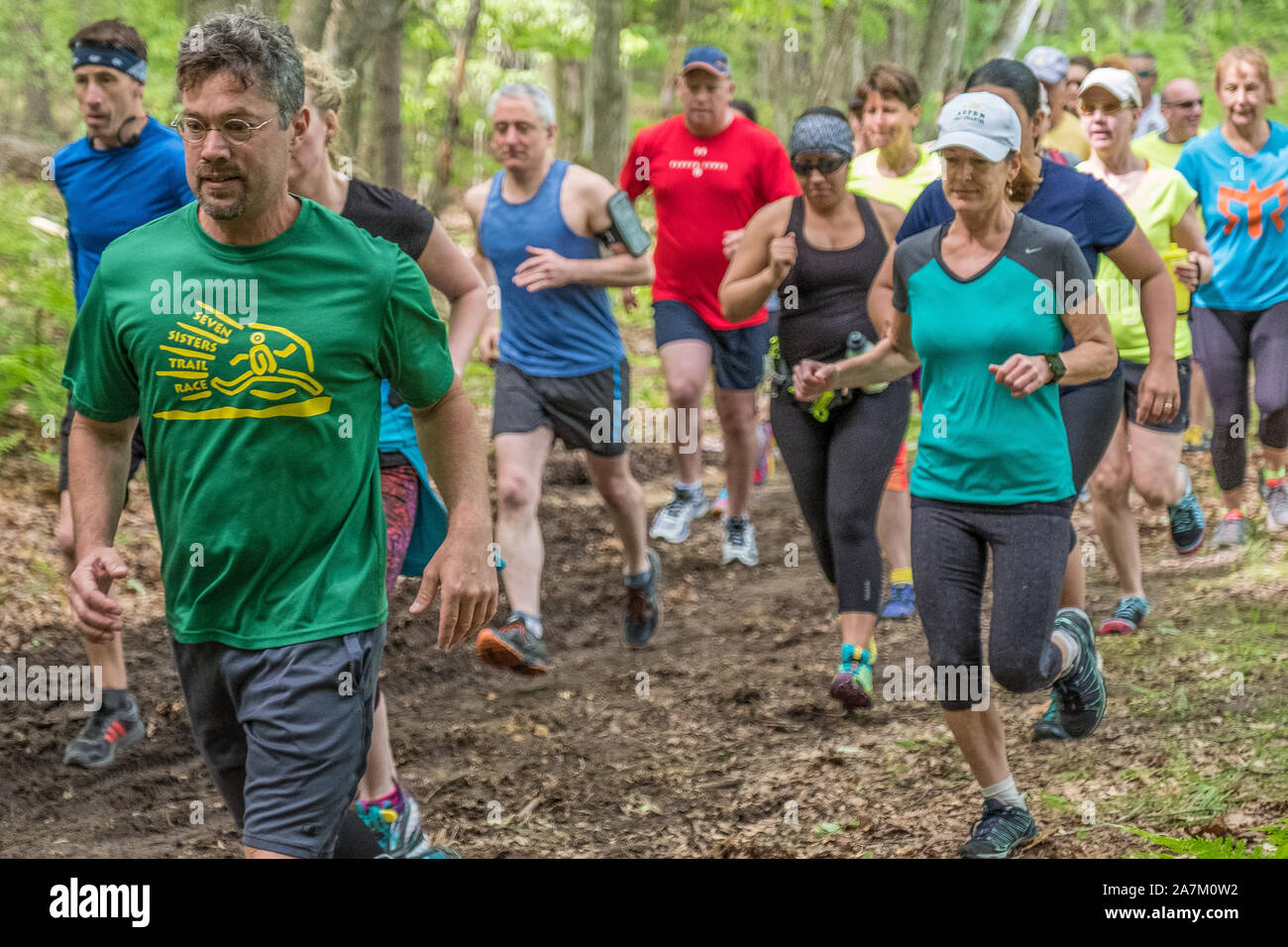 People running in a race along a wooded trail Stock Photo - Alamy