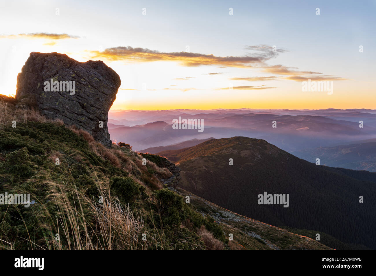 Sunrise over the cliff. The sun is hidden behind the mountain ...