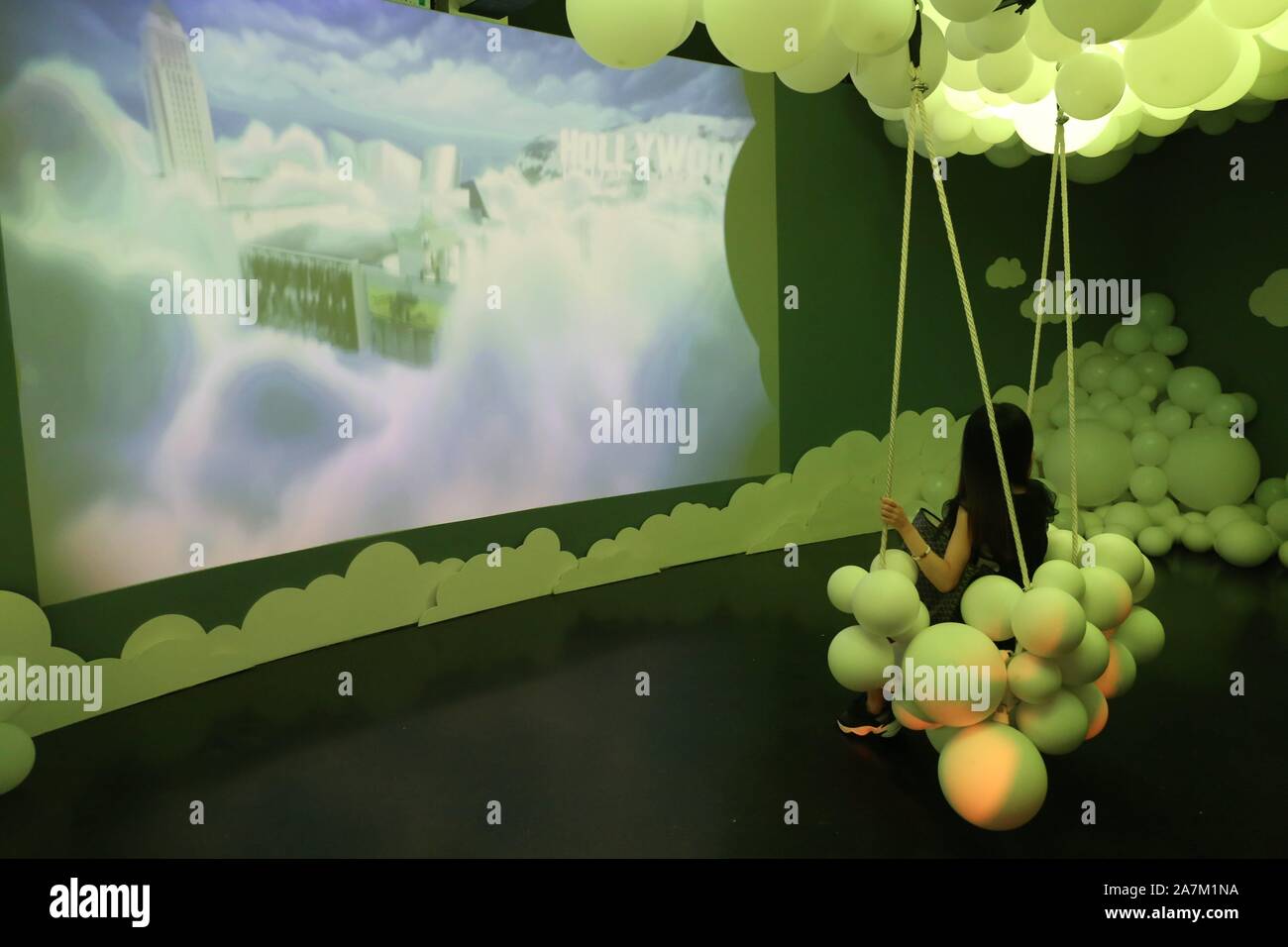 A visitor sits on the balloon swing in "A-Museum" in Shanghai, China, 4 ...