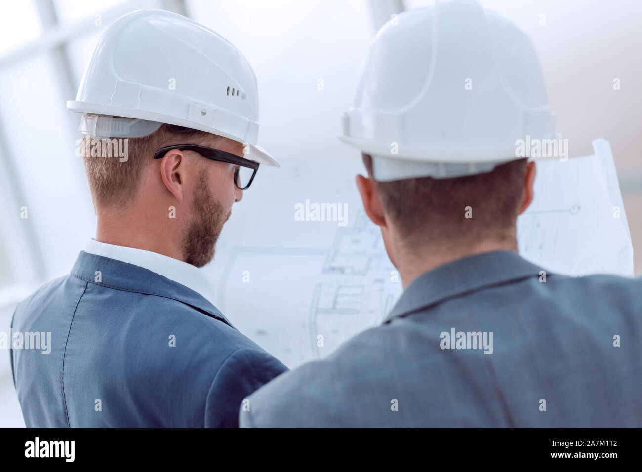 architect and engineer looking at blueprints of new project Stock Photo ...